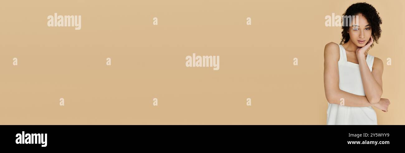 A stylishly dressed woman poses gracefully with confidence and poise ...