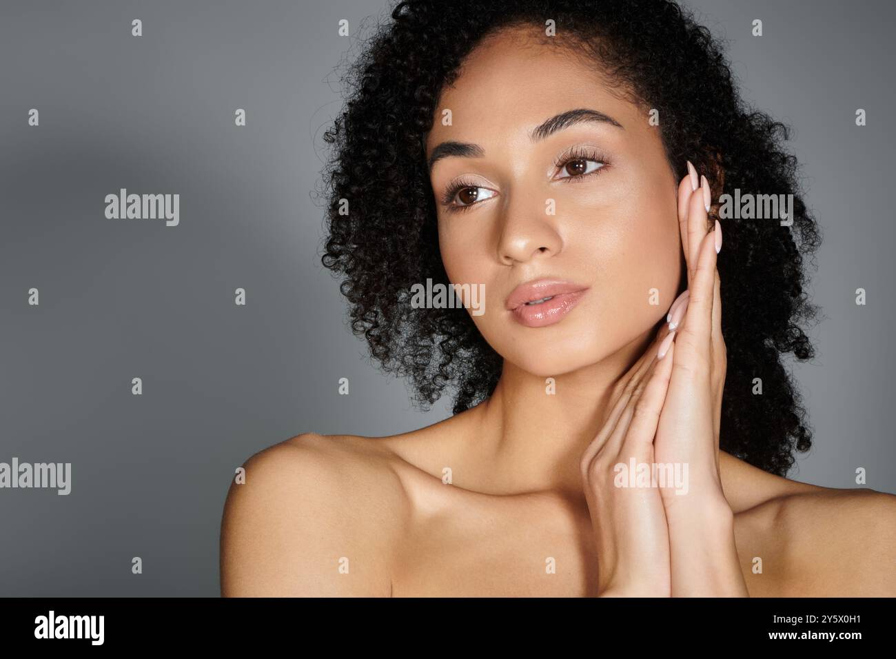 A fashionable woman displays her stylish look while posing gracefully ...