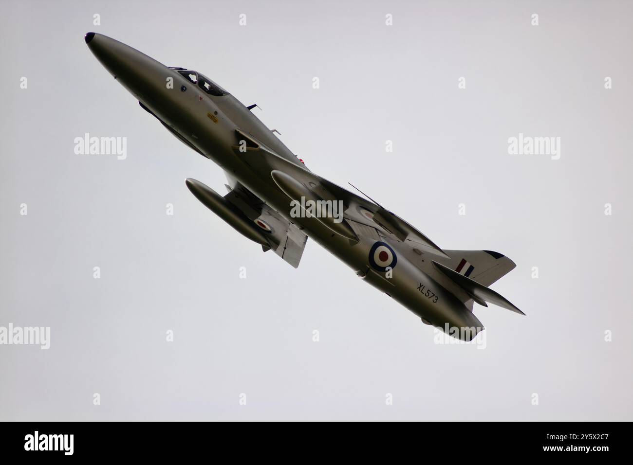 A vintage military jet aircraft in flight against a clear sky ...