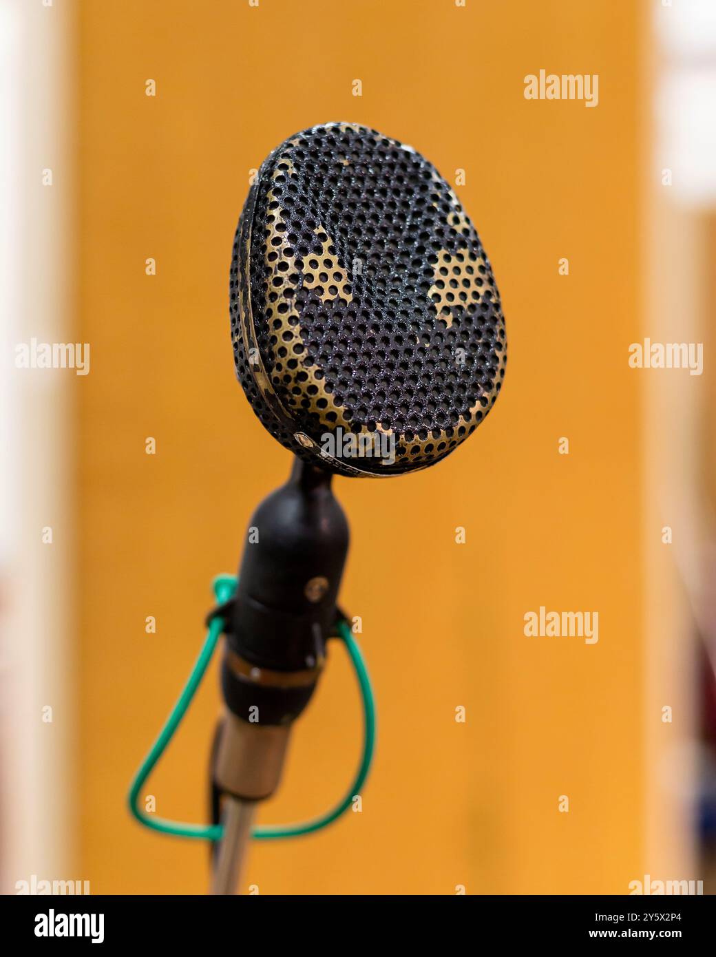 Vintage microphone against a blurred orange background on a microphone ...