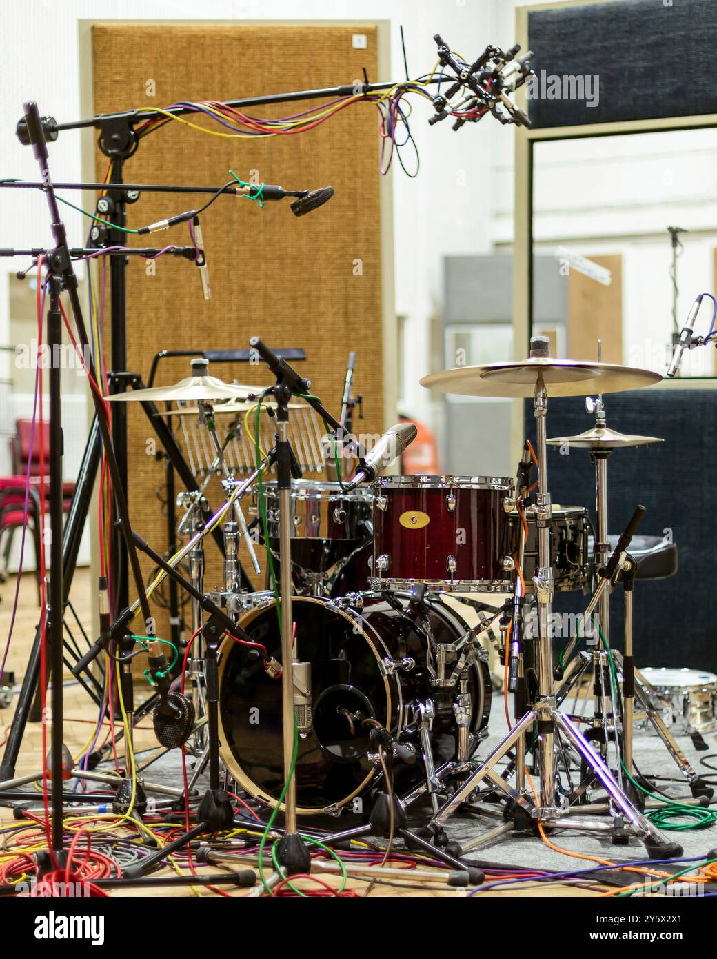 A professional drum set equipped with multiple microphones in a ...