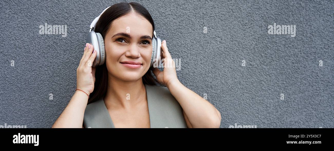 A brunette young woman with short stature delights in music while ...