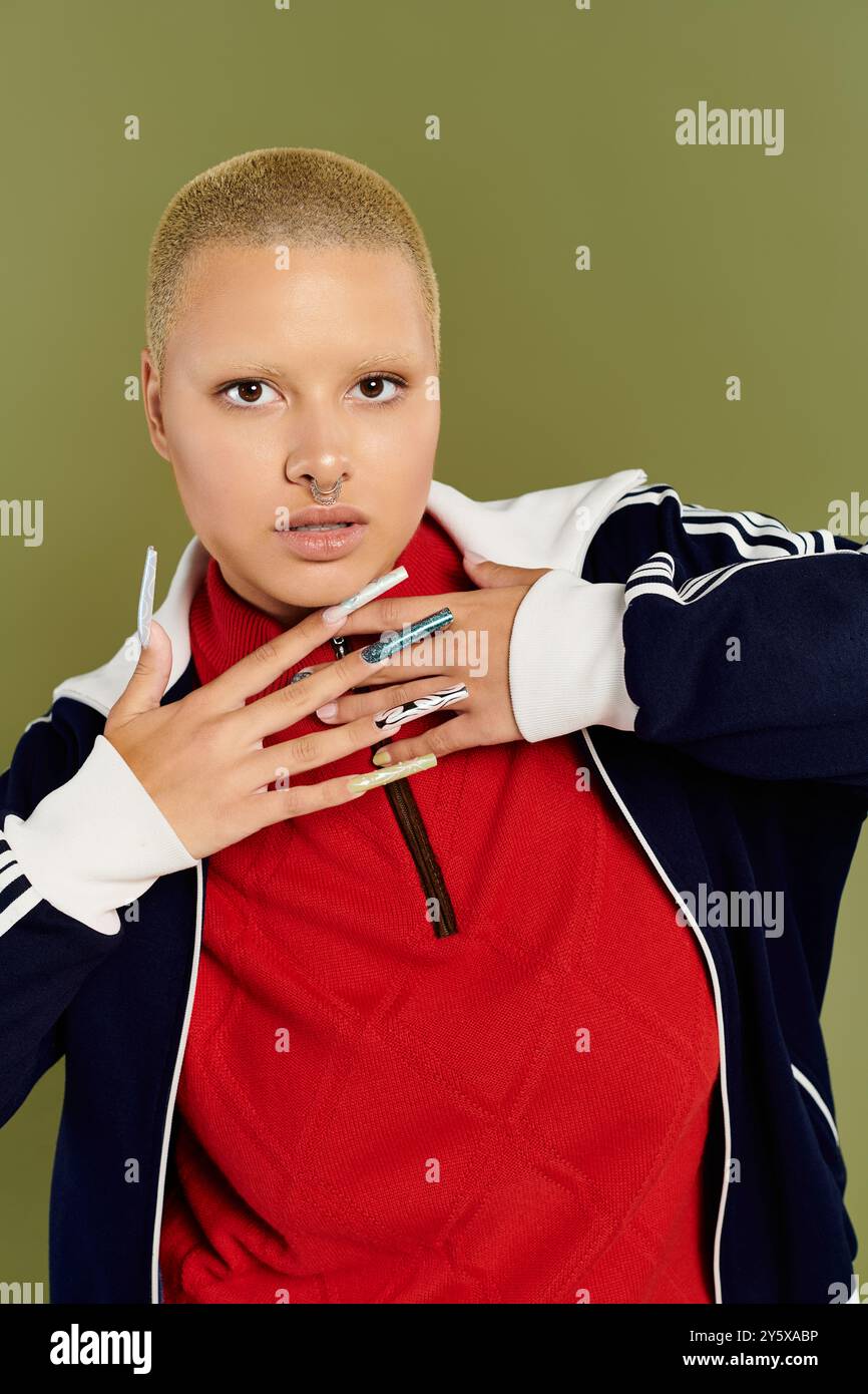 A young bald woman exudes confidence in vibrant clothing, striking a ...