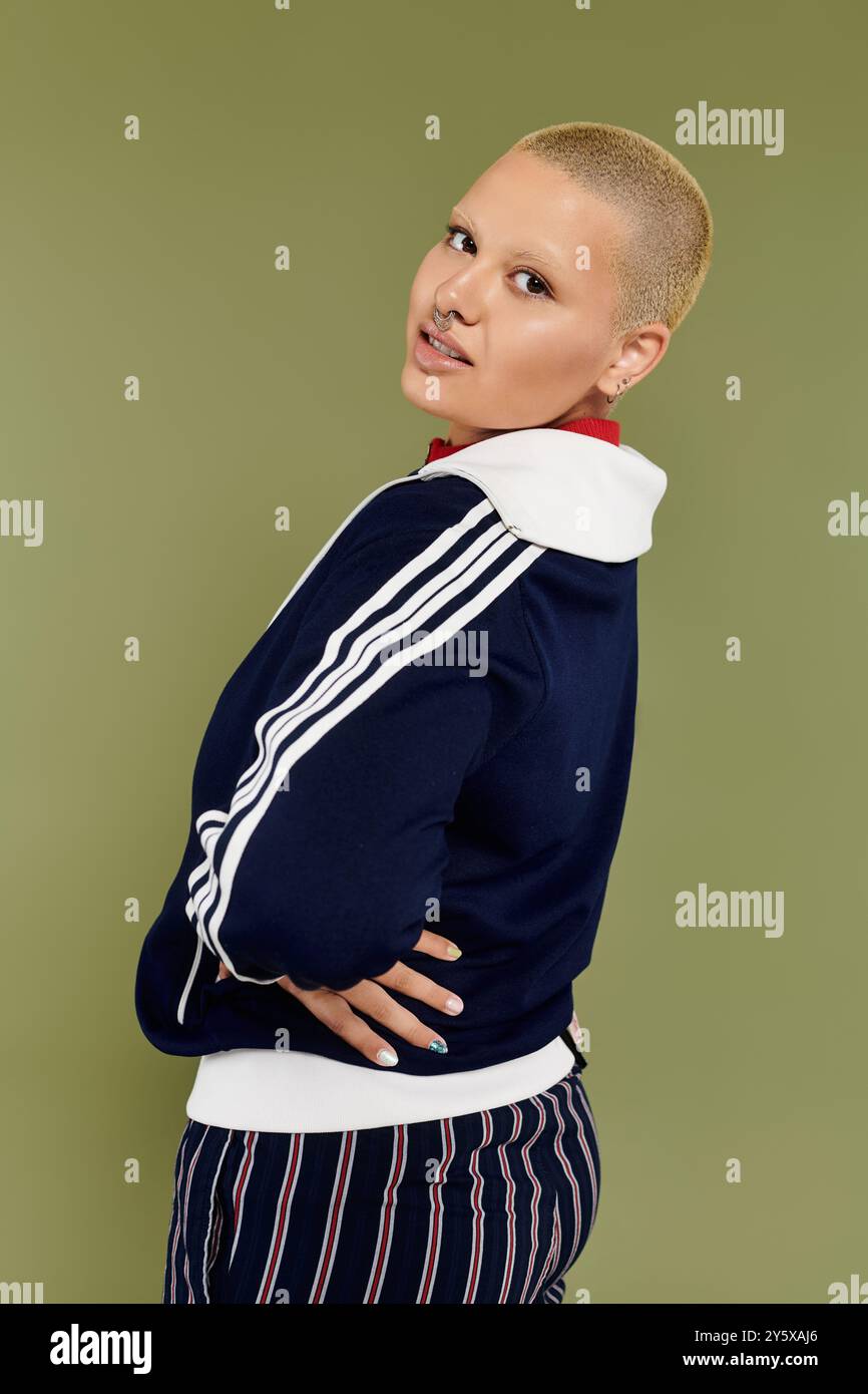 A young bald woman showcases her vibrant style, playfully posing in ...