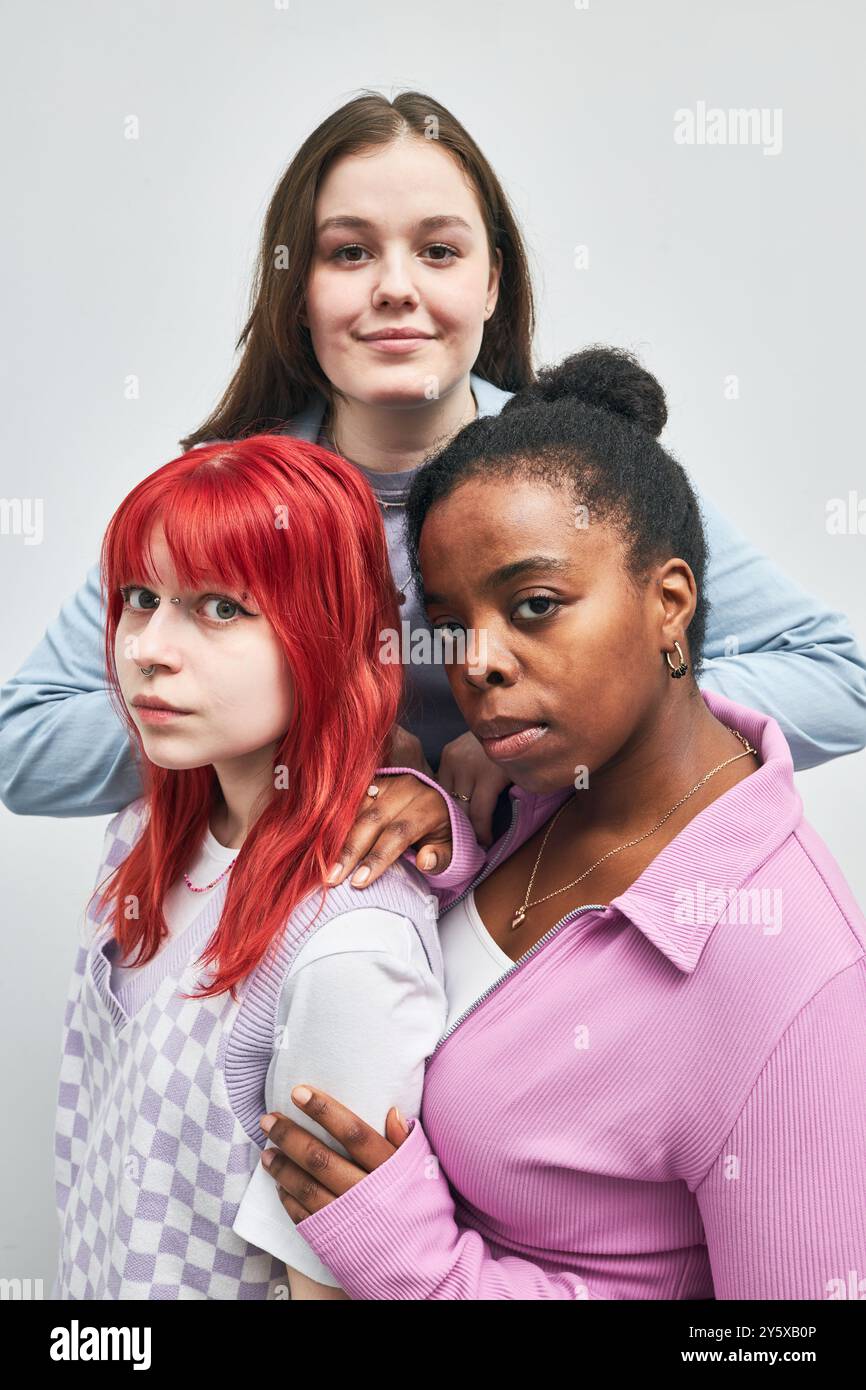 Three young diverse women embracing hi-res stock photography and images ...