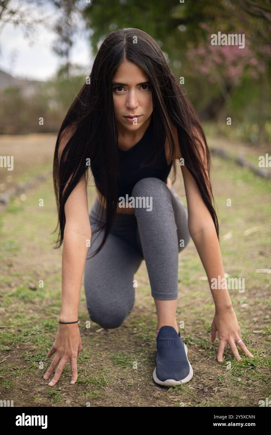 Young woman at starting point, running start posture, healthy lifestyle ...