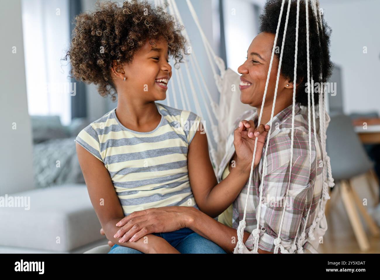 African american woman hugging her smiling teen daughter. Family love ...
