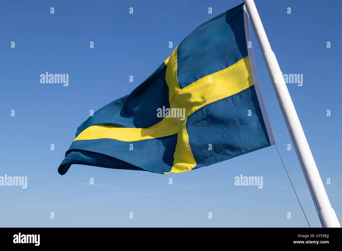 Swedish flag waving against a clear blue sky Stock Photo - Alamy