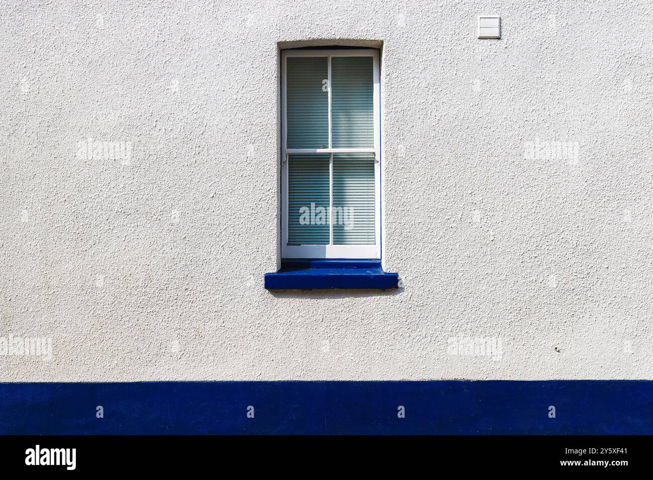 Single sash window set in white wall with Blue Sill and Blue footer ...