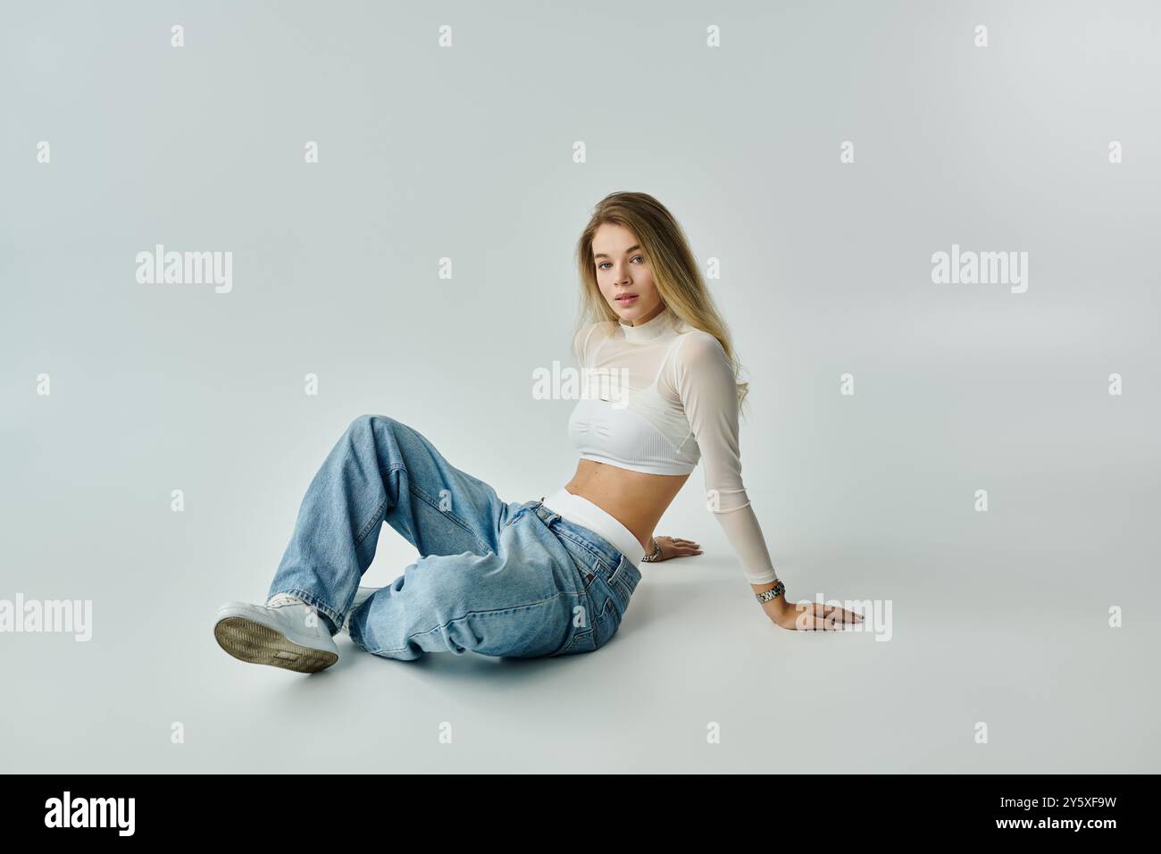 A stylish young woman poses confidently in trendy outfits, showcasing ...