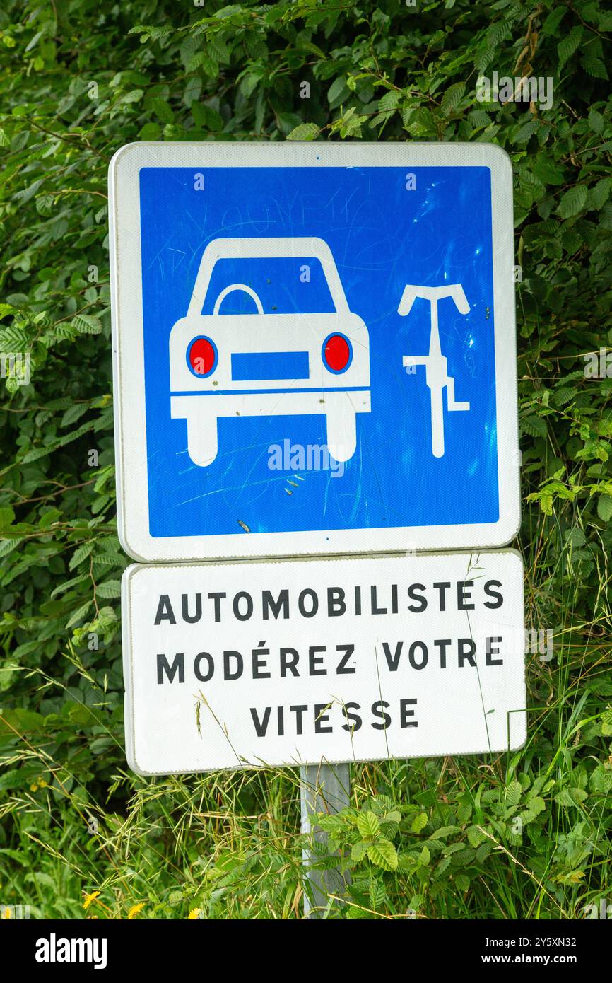 A French road sign asking motorists to slow down for cyclists ...
