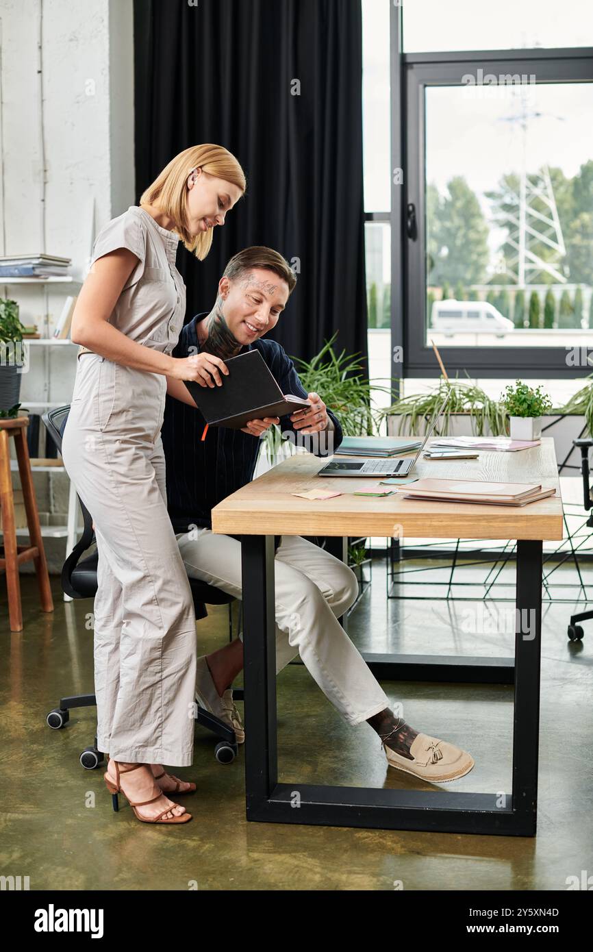 Two young professionals engage in lively discussion while reviewing ...