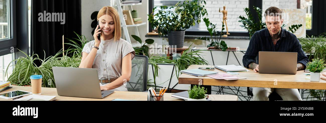 Two young professionals collaborate in a lively office space filled ...