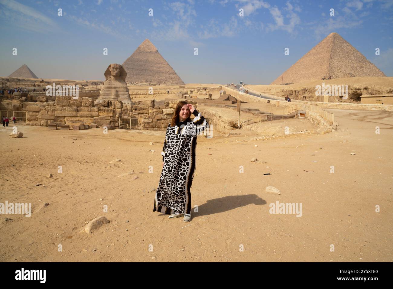 Back view of a woman in a long traditional Muslim dress looking at the ...