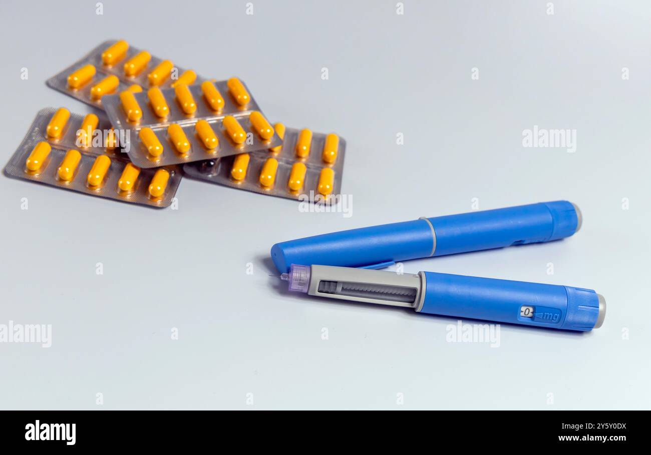 Ozempic Insulin injection pen for diabetics and weight loss and a bunch of pills Stock Photo - Alamy