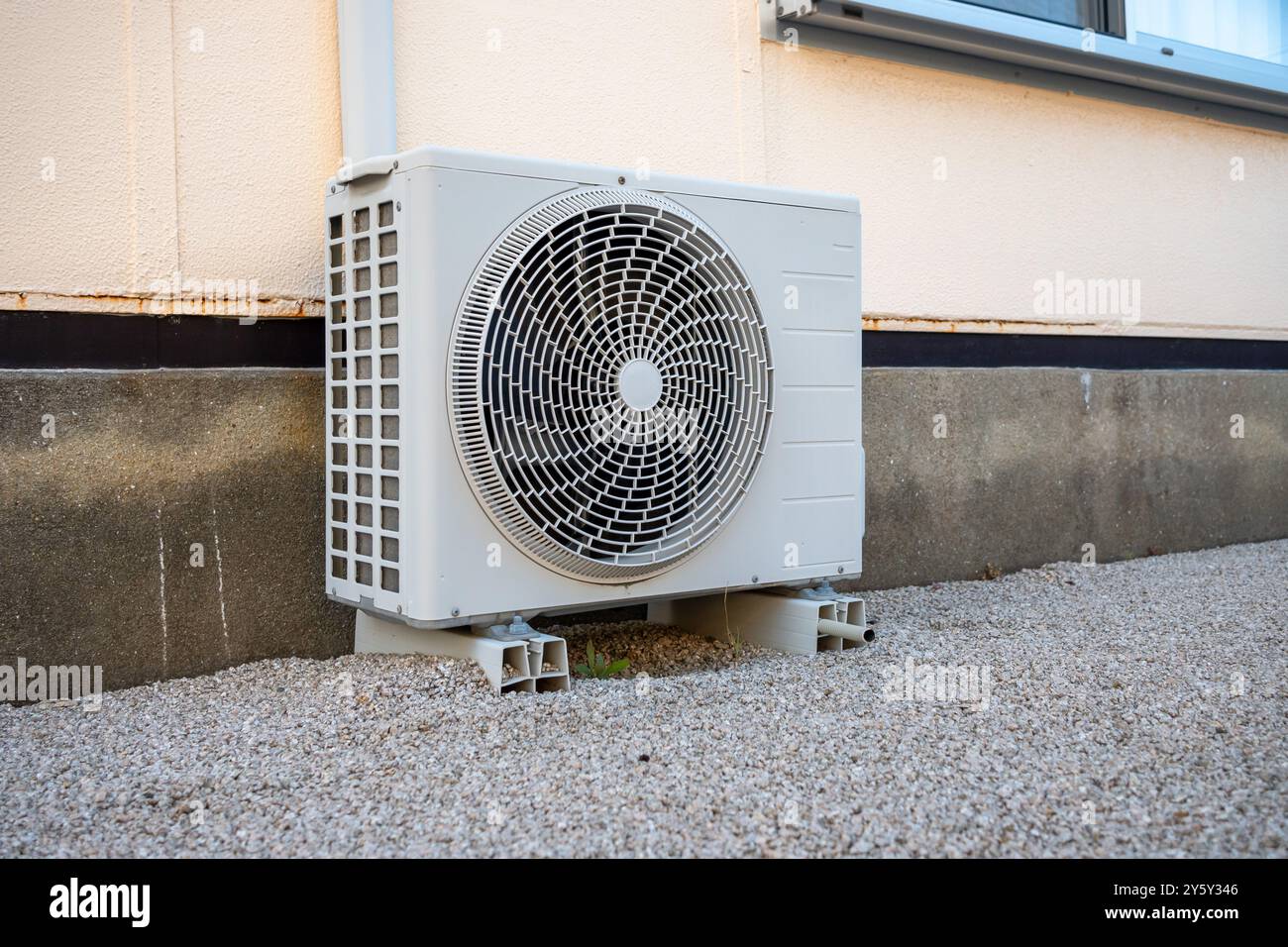 Aircon compressor outside a house Stock Photo - Alamy