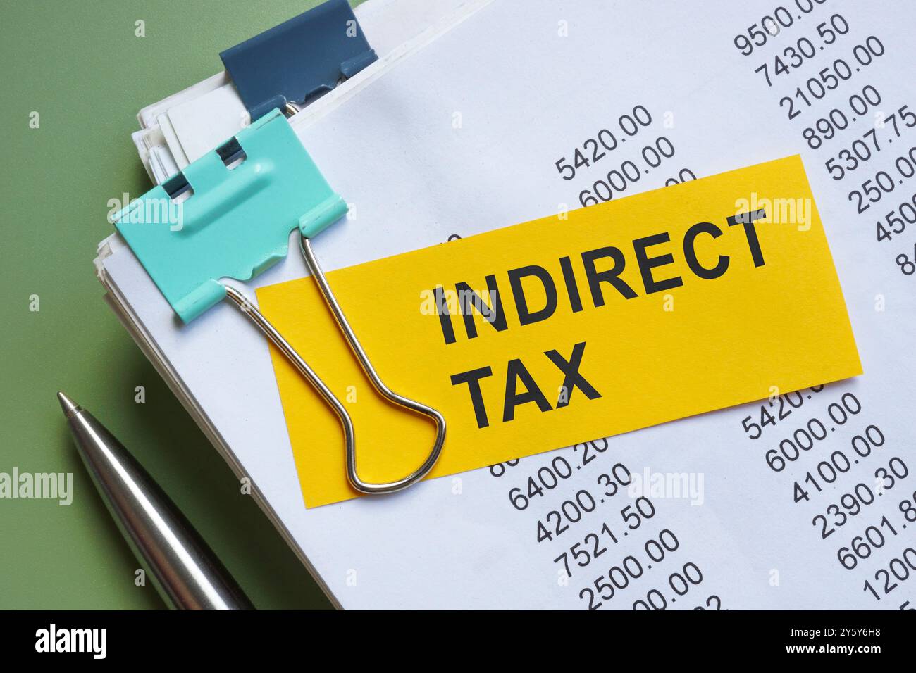 Stack of papers with a note about indirect tax Stock Photo - Alamy