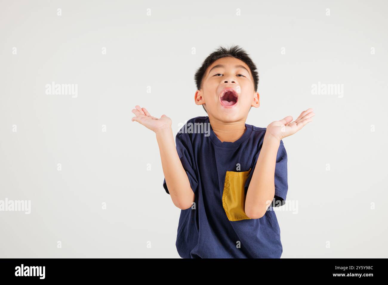 A jubilant kid boy raises her fists in celebration of her success ...