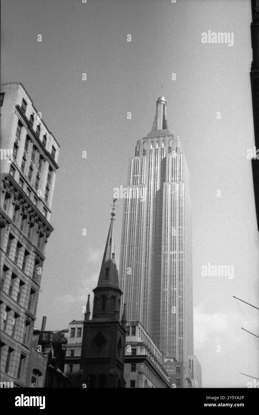 A New York City church spire and the Empire State Building C. 1952 ...