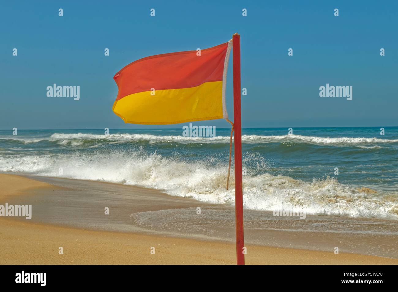 Beach flag indicating current level of safety for swimming and surfing ...