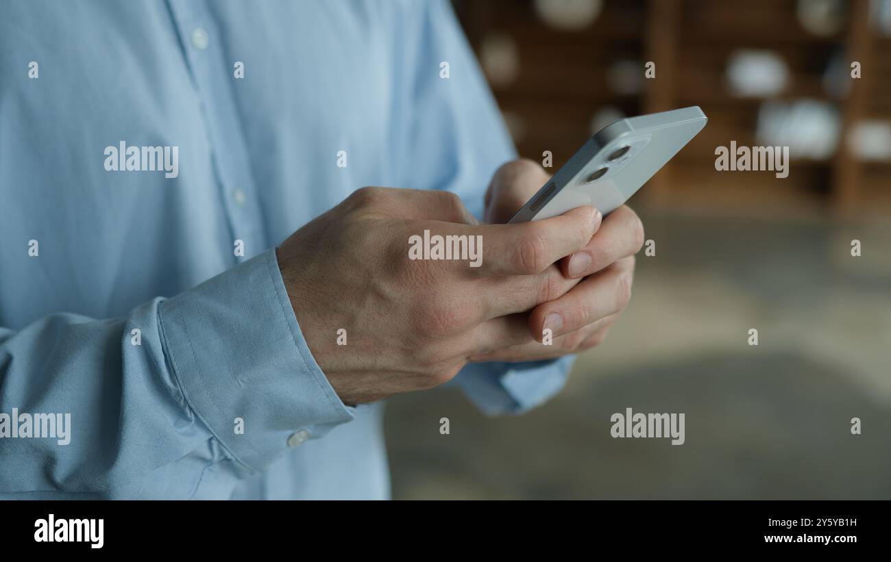 Side view unknown young Caucasian man businessman user male hands hold ...