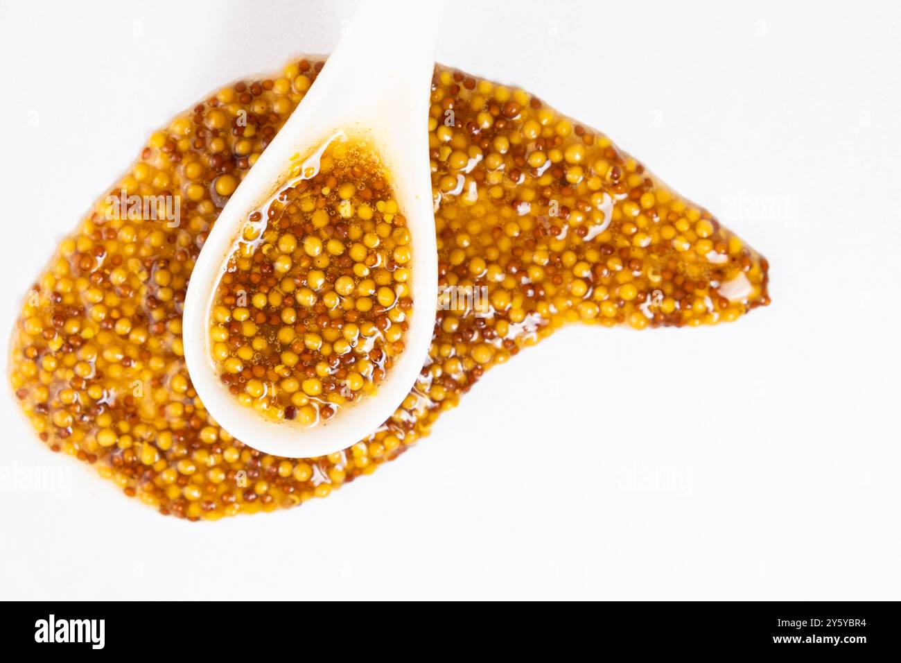 Traditional French Dijon mustard in a spoon on a white background Stock ...