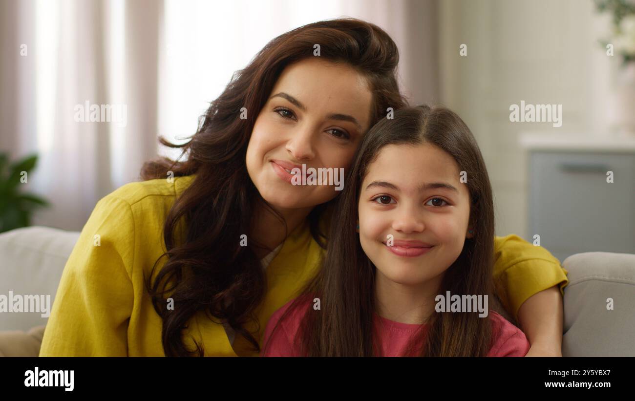 Happy loving Caucasian family portrait. Smiling woman female mom parent mother hugging little ...