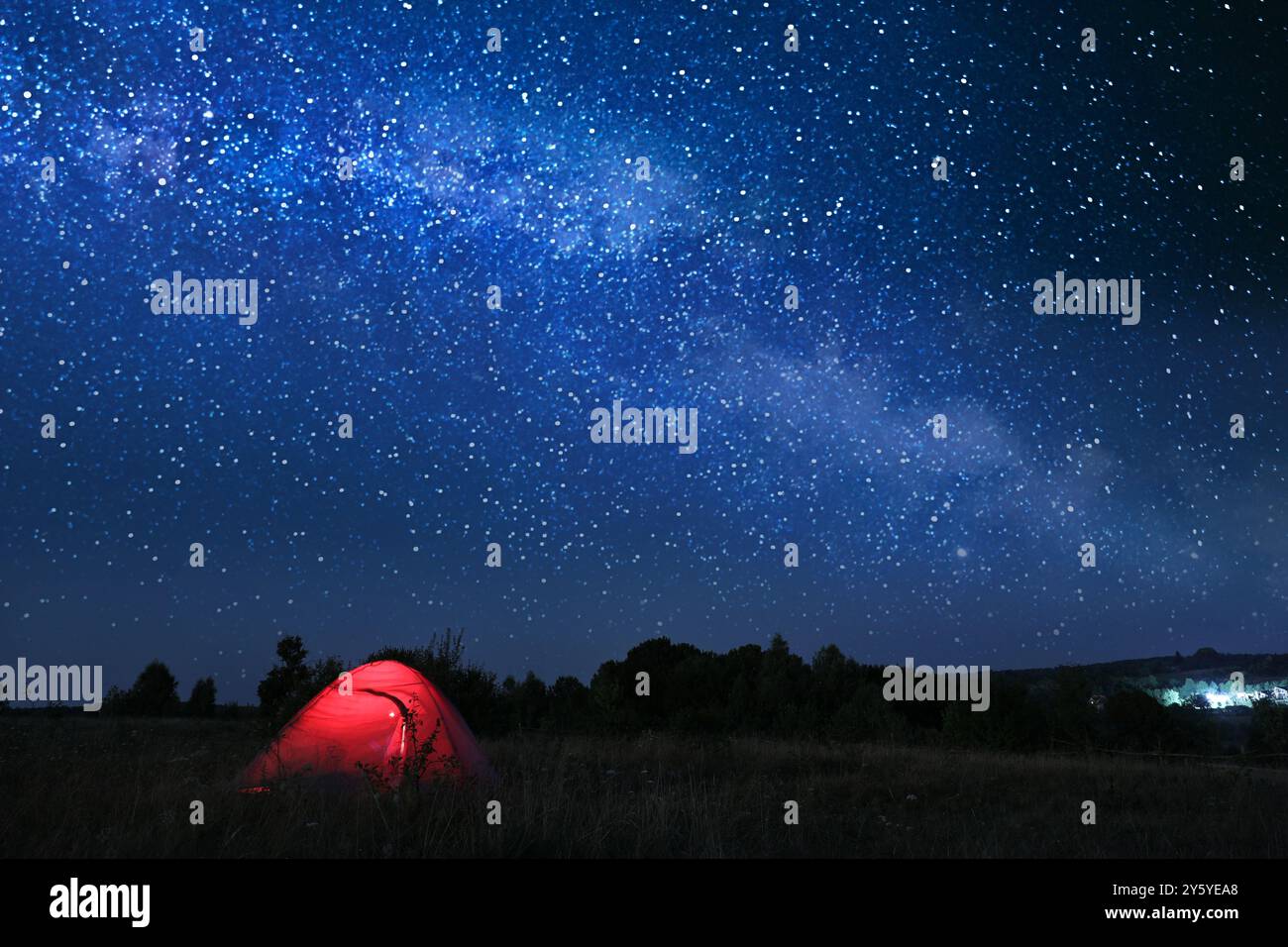 Modern camping tent in wilderness at night, slow shutter speed effect ...