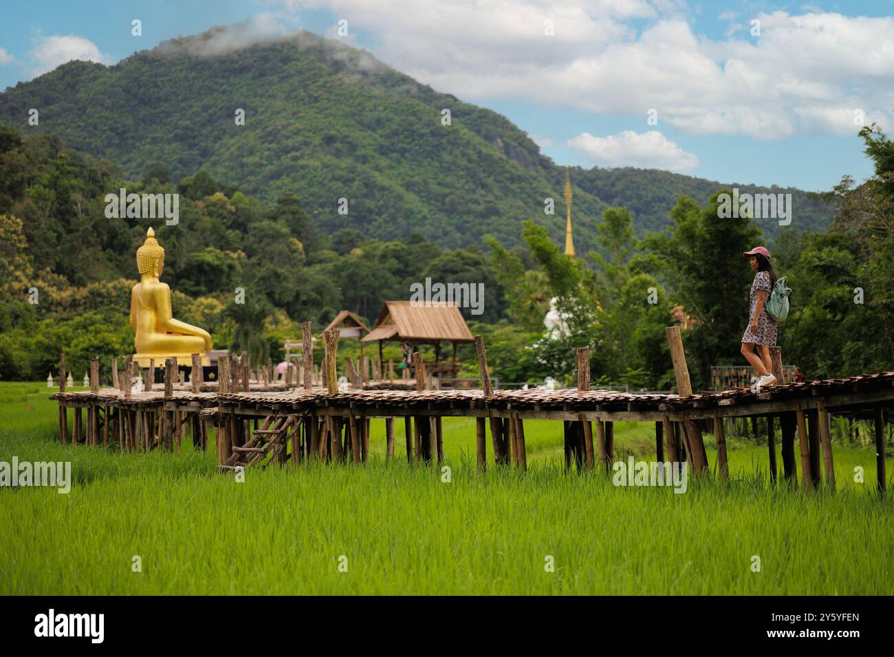 Tourist woman visiting the Na Khuha temple in the middle of rice field ...
