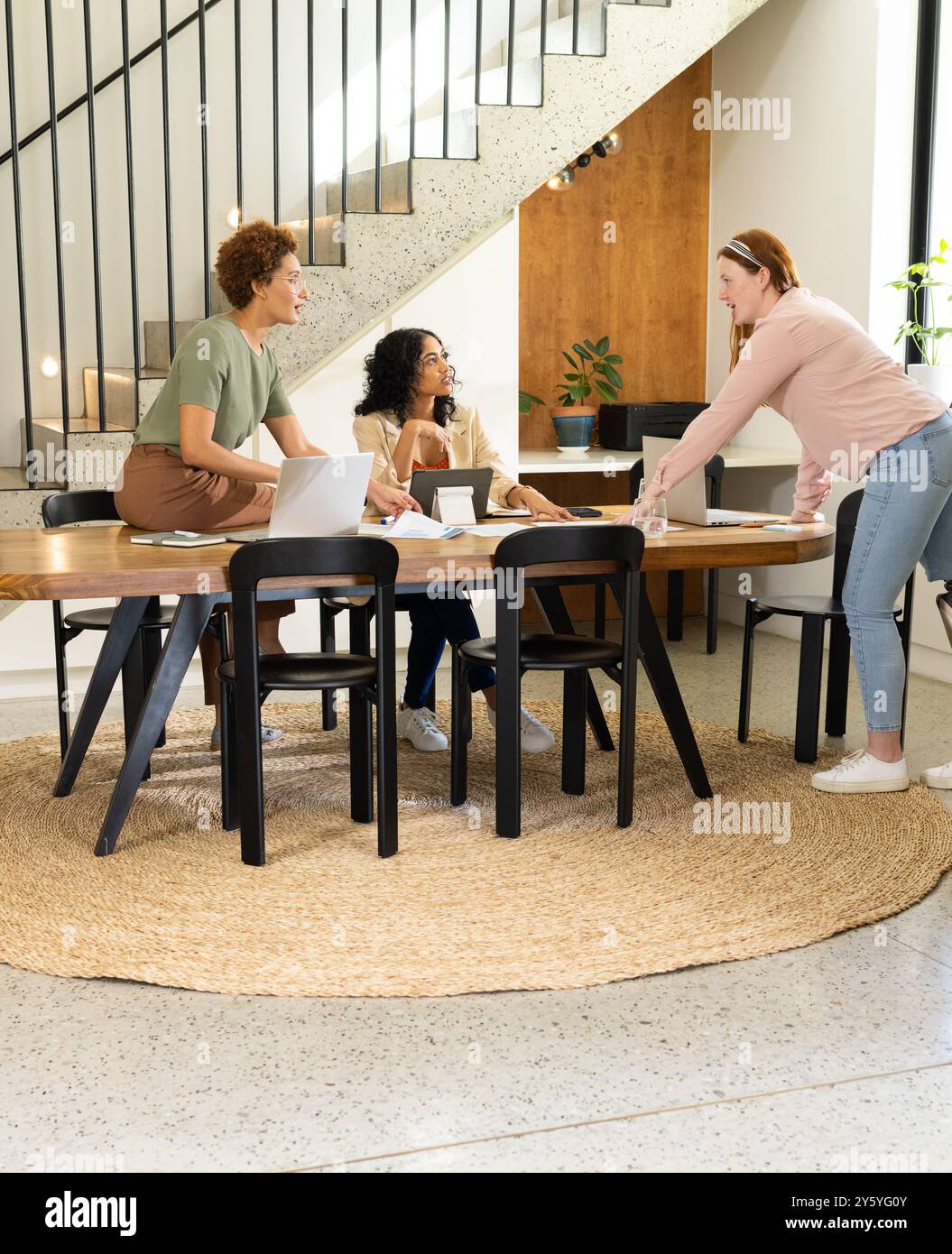 Collaborating around table, diverse women friends discussing ideas and ...