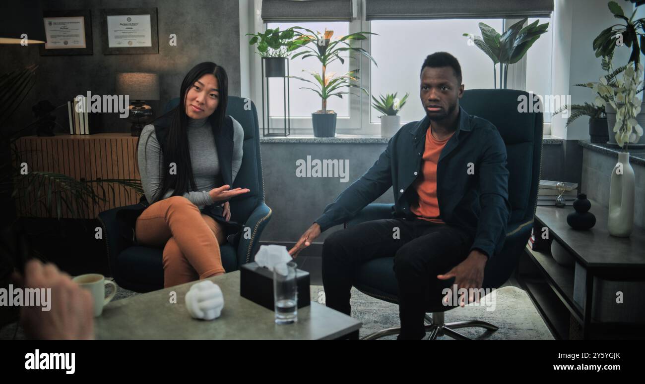 Back view of therapist conducting counseling session to multiethnic ...