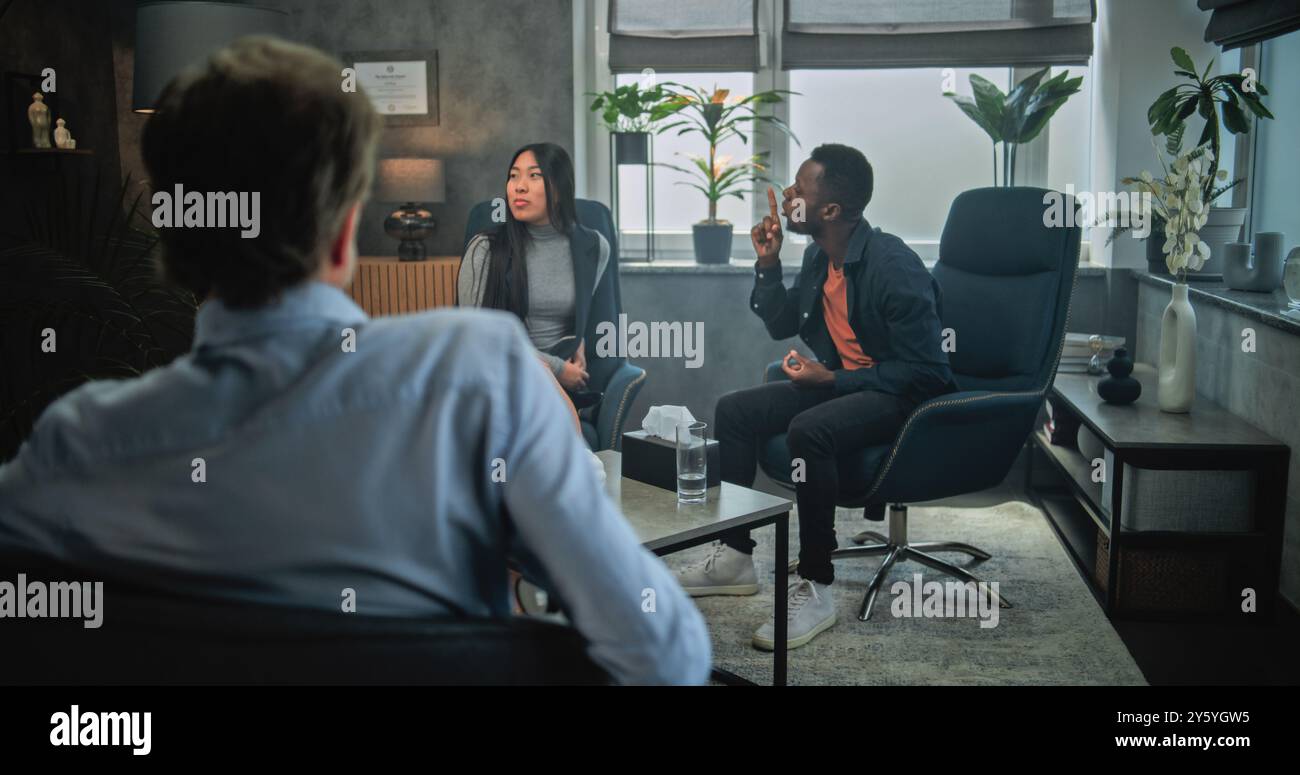 Back view of therapist conducting counseling session to multiethnic ...