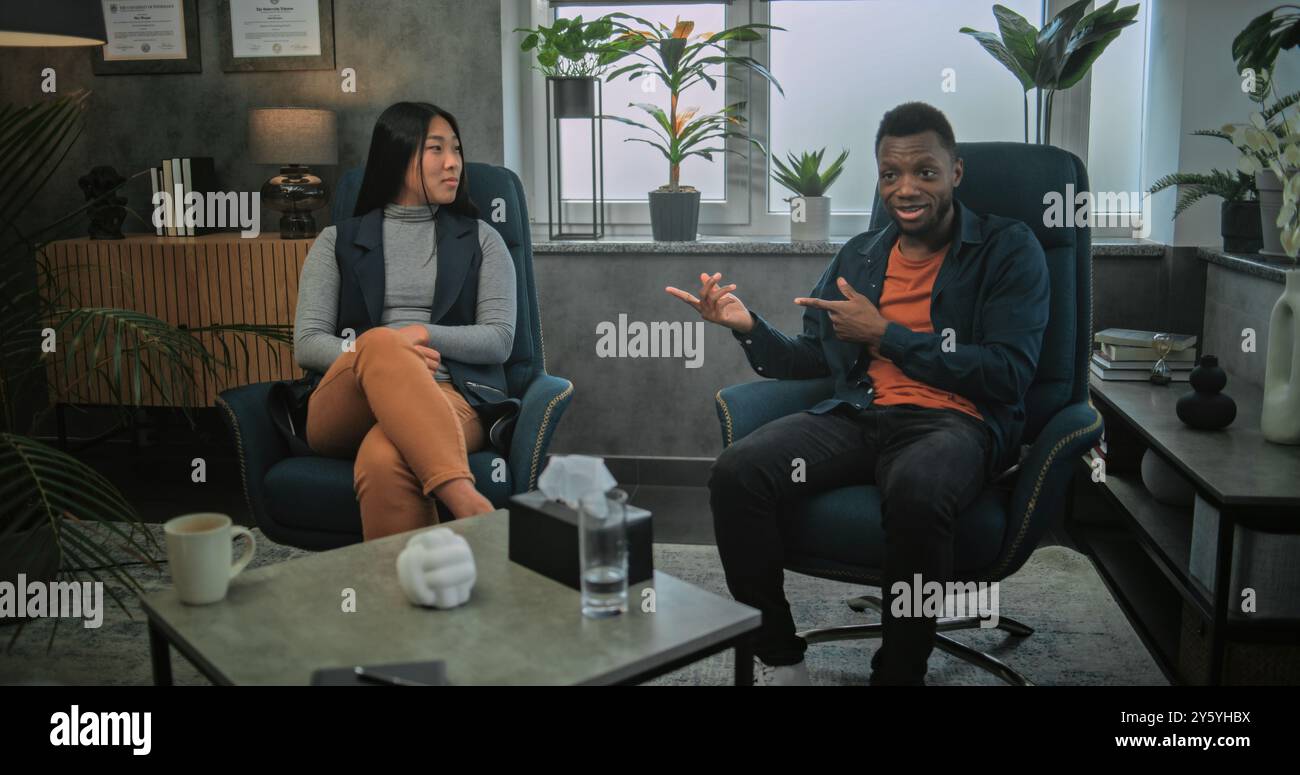 Back view of therapist conducting counseling session to multiethnic ...