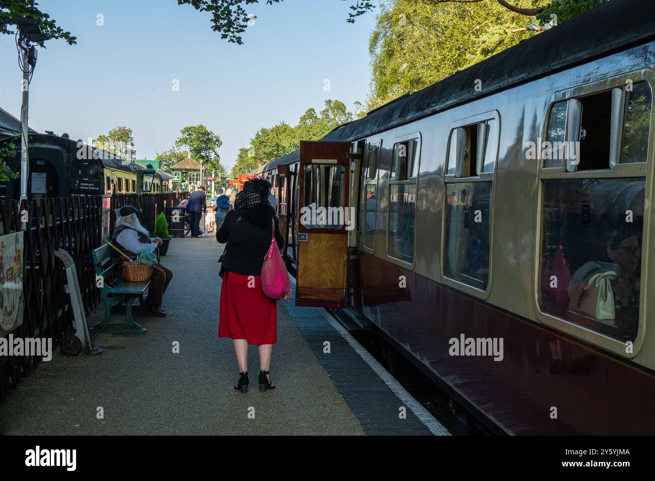 Holt, Norfolk, UK - SEPTEMBER 21 2024: Woman in red 1940s dress and ...