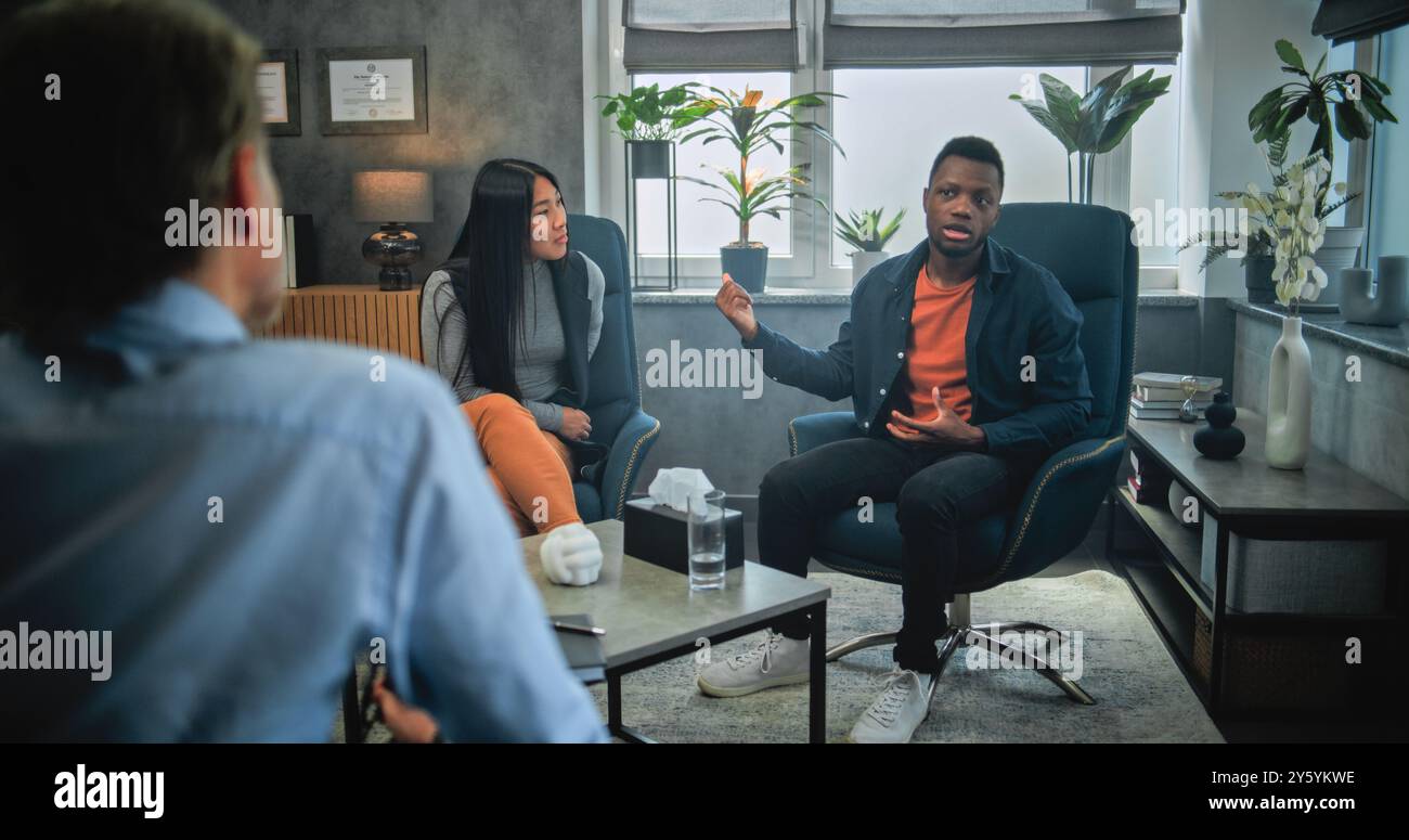 Back view of therapist conducting counseling session to multiethnic ...