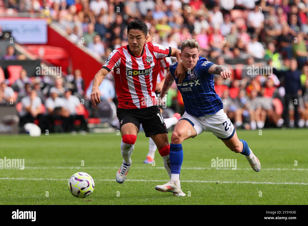 Sam Szmodics of Ipswich Town is pulled back by Yukinari Sugawara of ...
