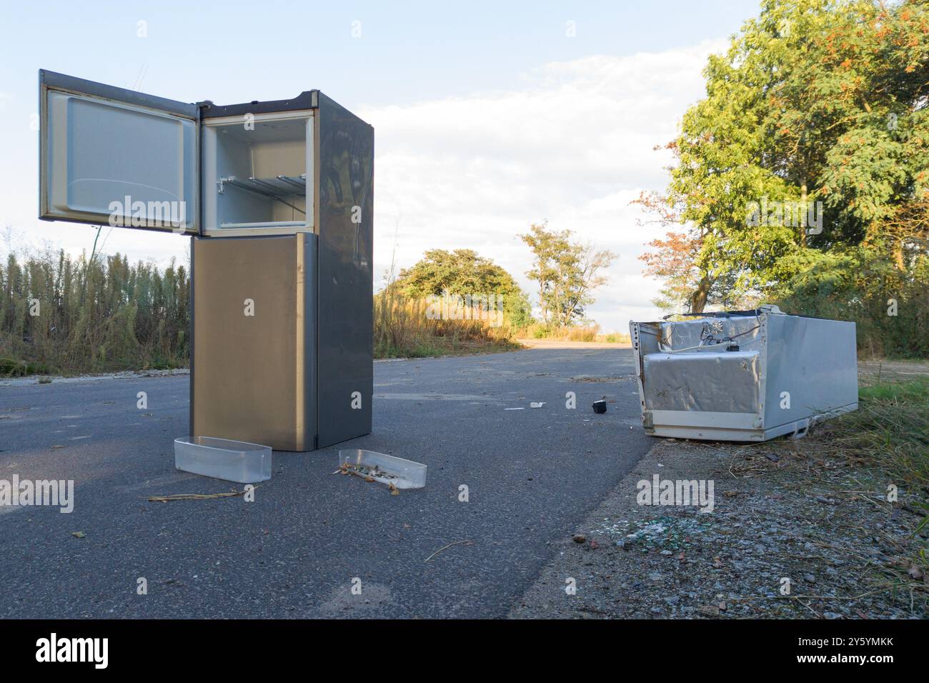 Discarded refrigerator and broken appliance on the roadside Stock Photo ...