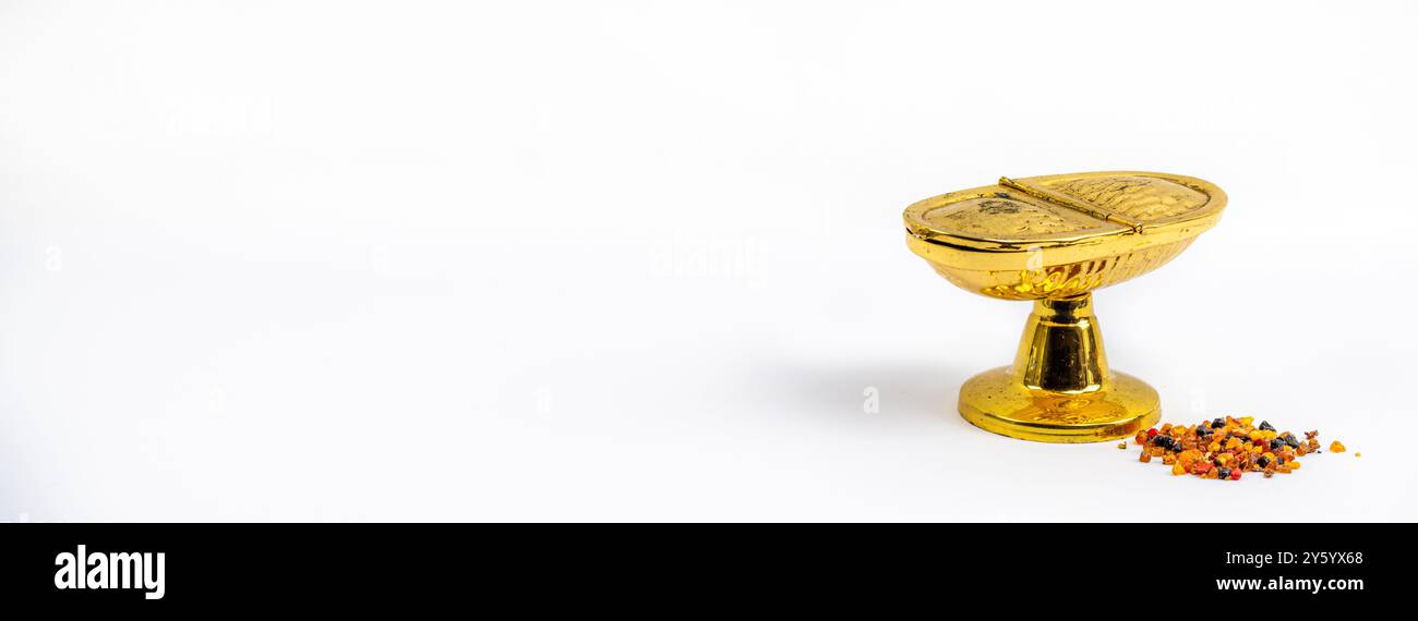 Golden incense container and grains of incense Stock Photo - Alamy