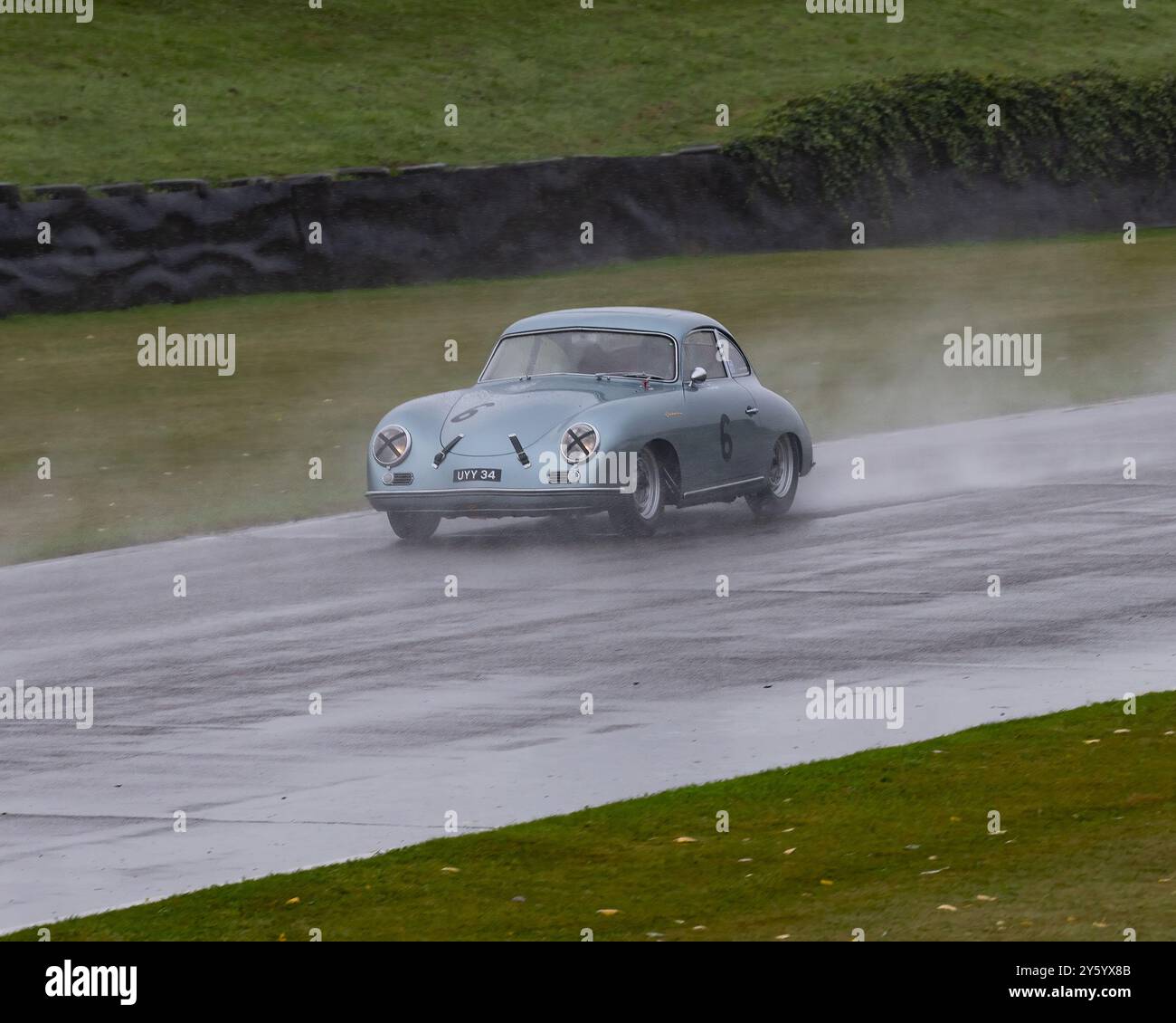 1955 Porsche 356 registration UYY34 racing in the rain and spray at the ...