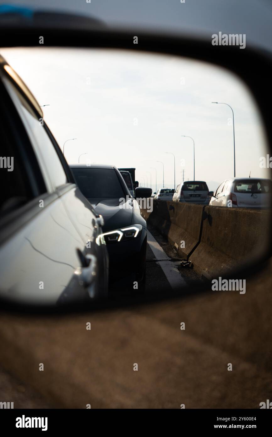 mirror reflection of car headlight on road with barriers Stock Photo ...