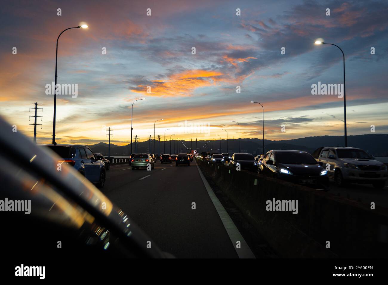 sunset skyline on the road with cars on Penang bridge Stock Photo - Alamy
