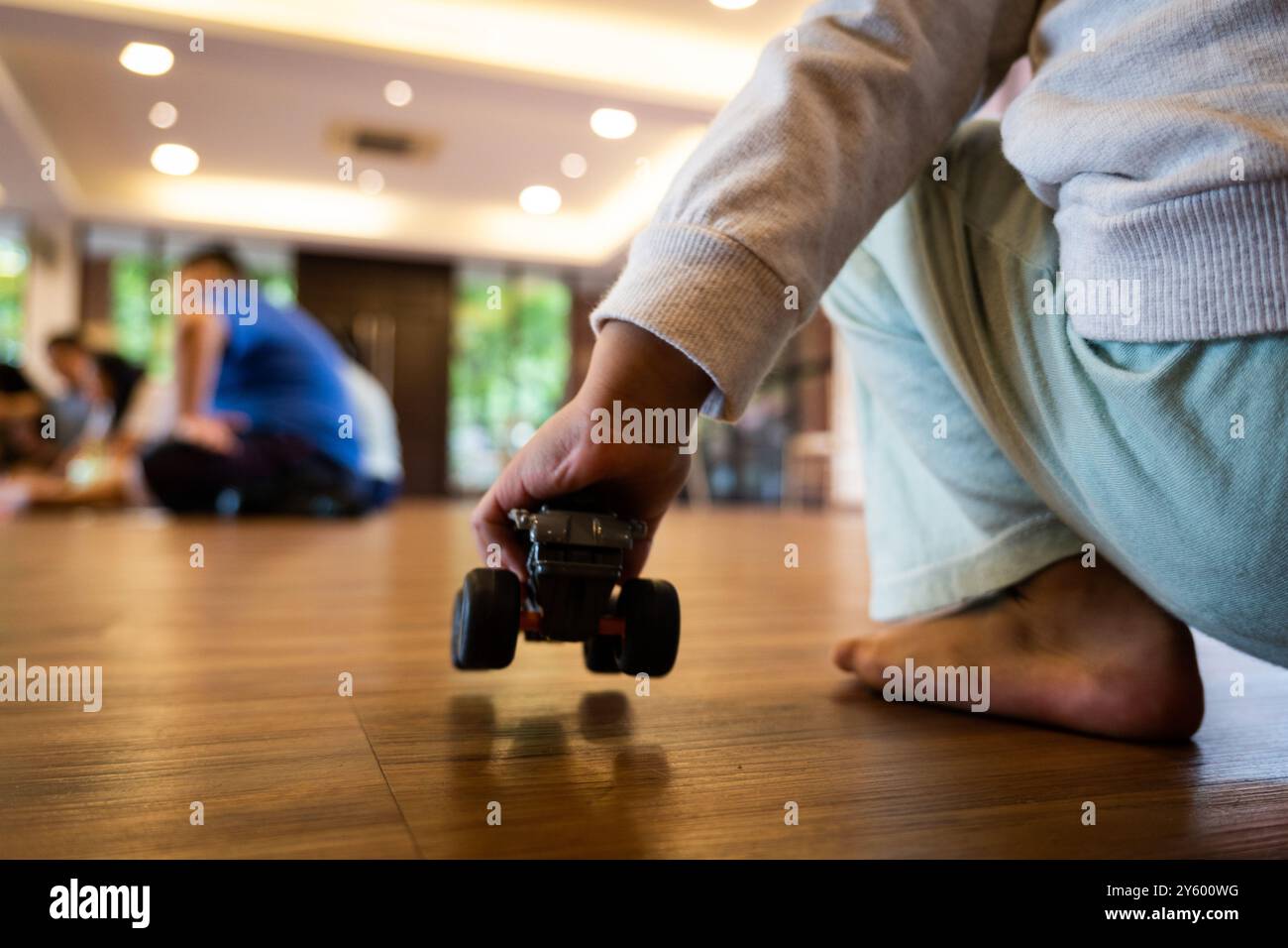 baby kid playing toy car in hall with others on the floor Stock Photo ...