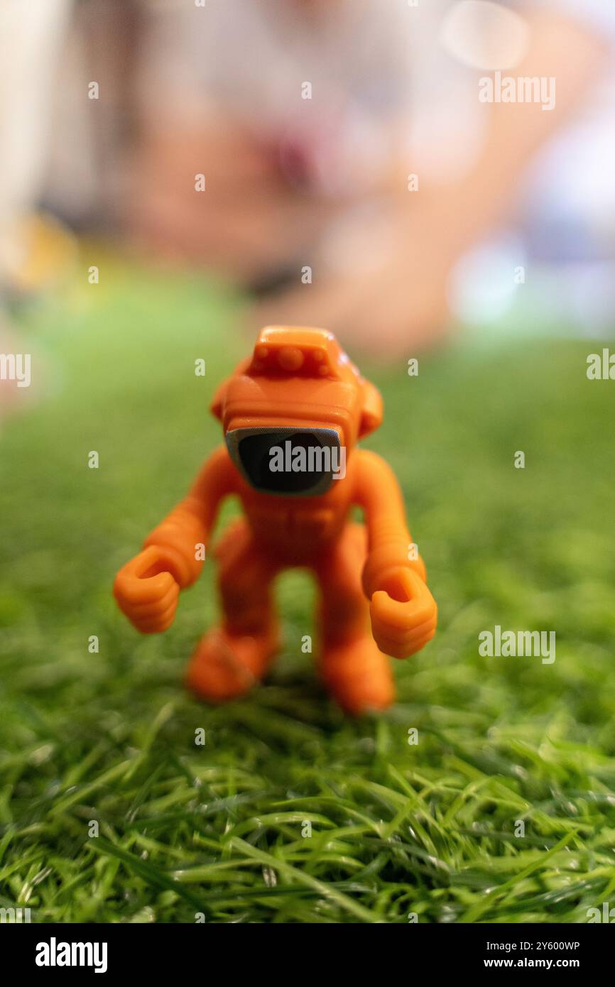 orange toy robot monkey on green grass standing Stock Photo - Alamy