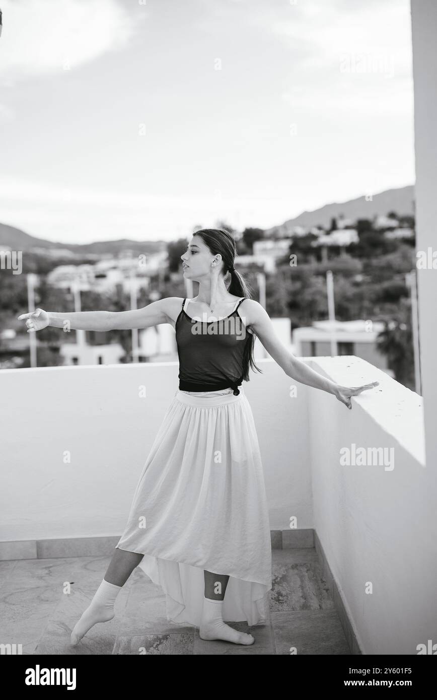 A Graceful Dancer Posing Elegantly on a Scenic Balcony Amidst Beautiful ...