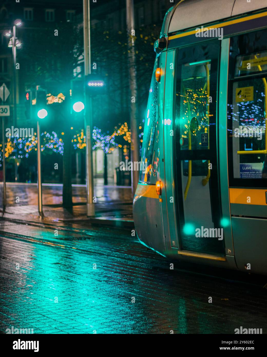 Night scene of Dublin with a Luas tram on a rainy evening, framed ...