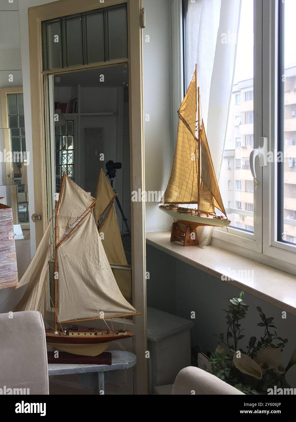 Model sailboats as nautical decor by a window. Nostalgia, adventure ...