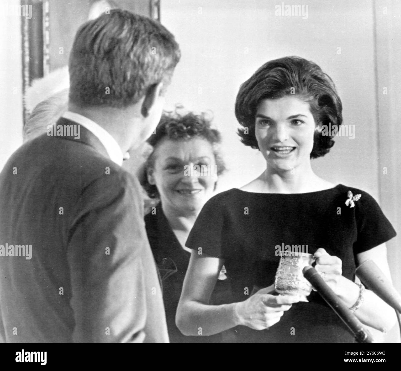JACQUELINE KENNEDY IS SHOWING JOHN F KENNEDY THE SILVER CHRISTENING CUP ...