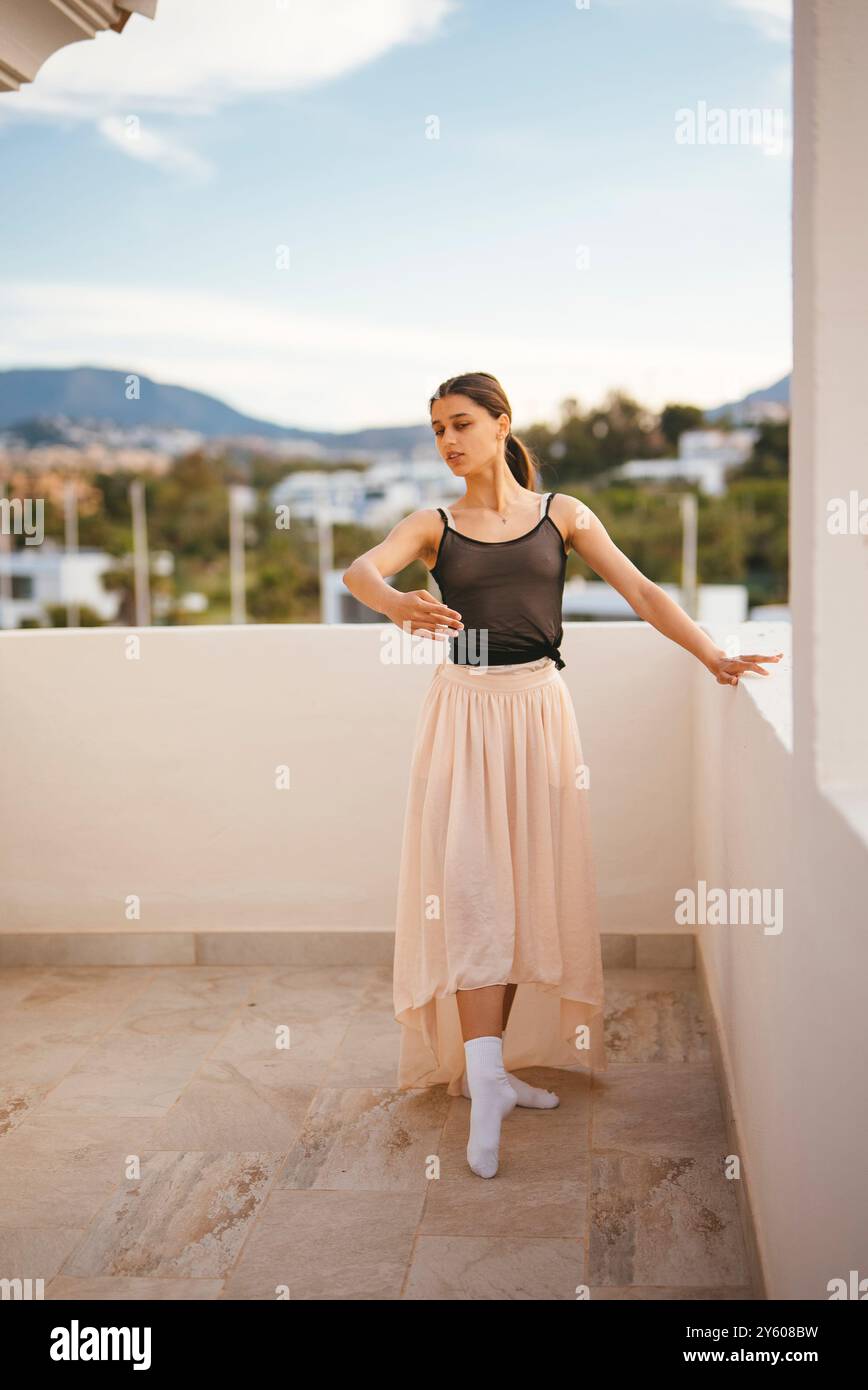 A Graceful Dancer is Posing Elegantly on a Beautiful Balcony with a ...