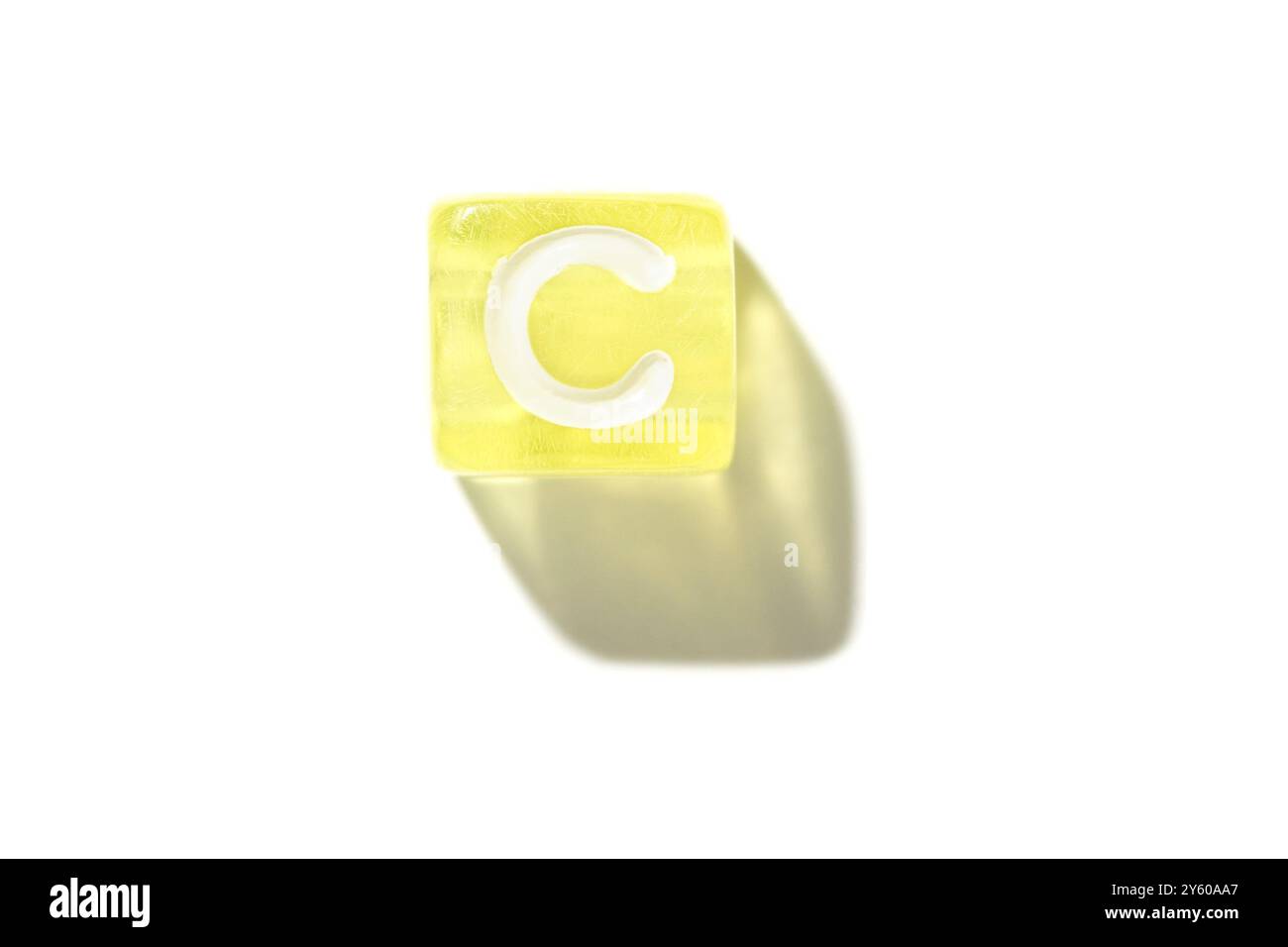 Yellow transparent cube with letter c shadow on white background ...