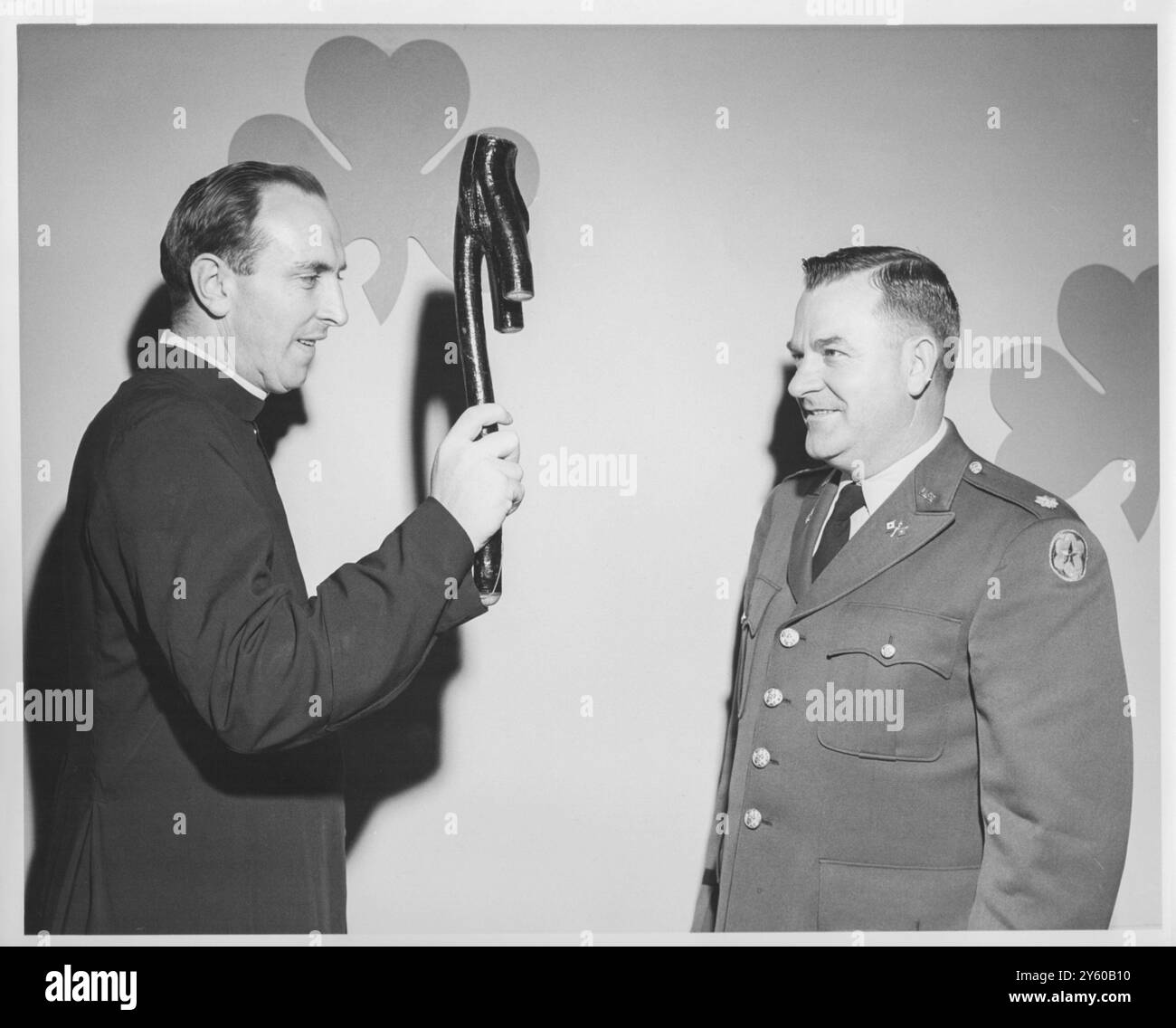 Catholic priest presenting a shillelagh to a field grade army officer ...
